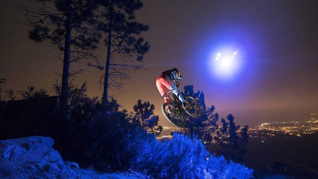 Downhill mountain biker rides full throttle at night with only a drone ...