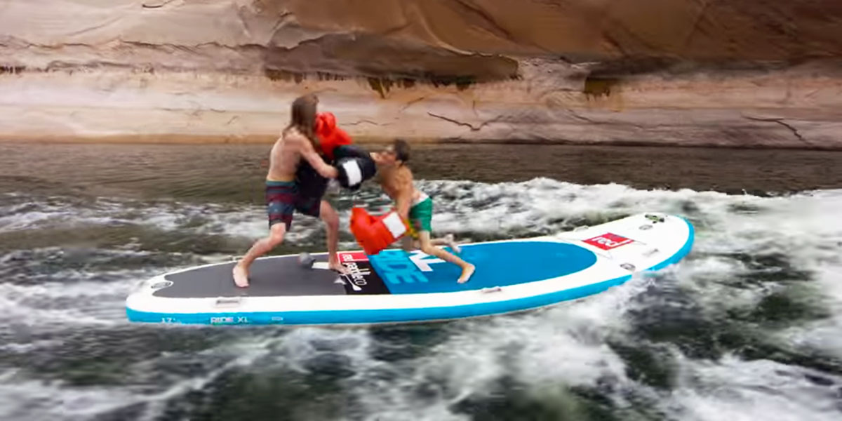 Duo challenged to crazy boxing match on a stand up paddle board...being ...